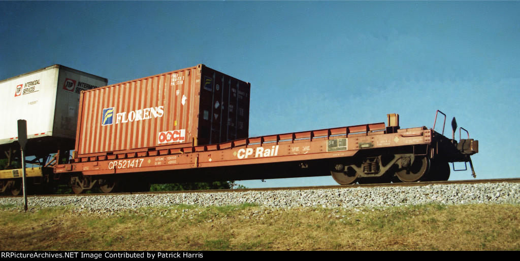 CP 521417 50 TOFC-COFC flat car converted from box car with 20 Florens-OOCL container sitting ...